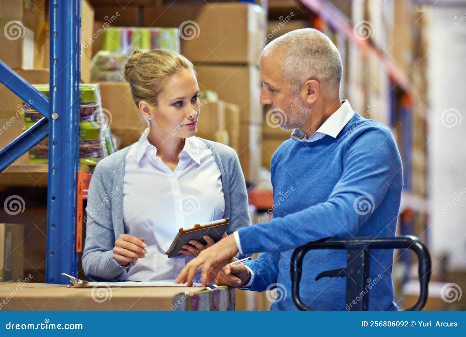Working Well Together. Two Colleagues Having a Discussion while Doing ...
