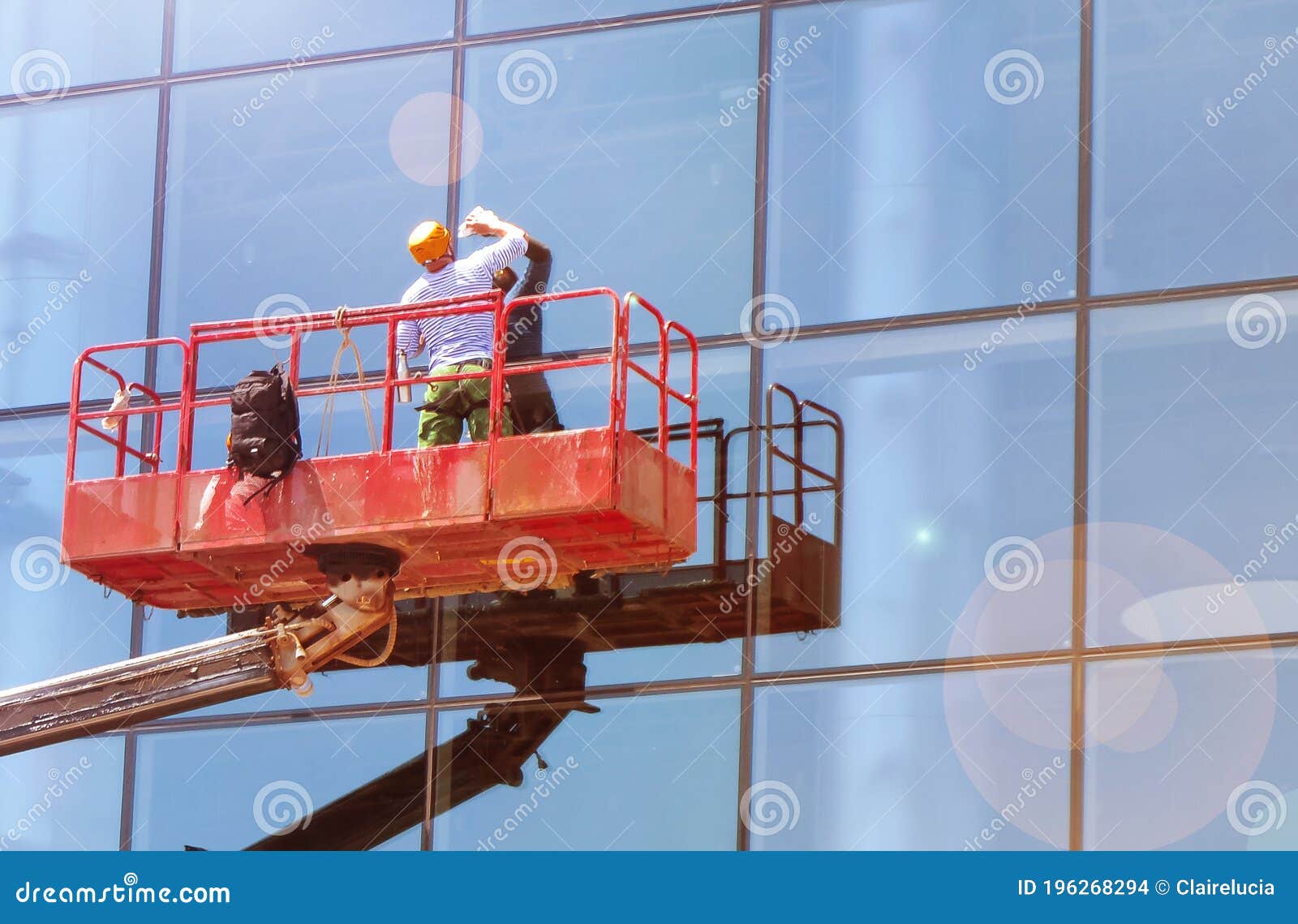 Working Window Cleaner on a Telescopic Platform Washes the Windows of a ...