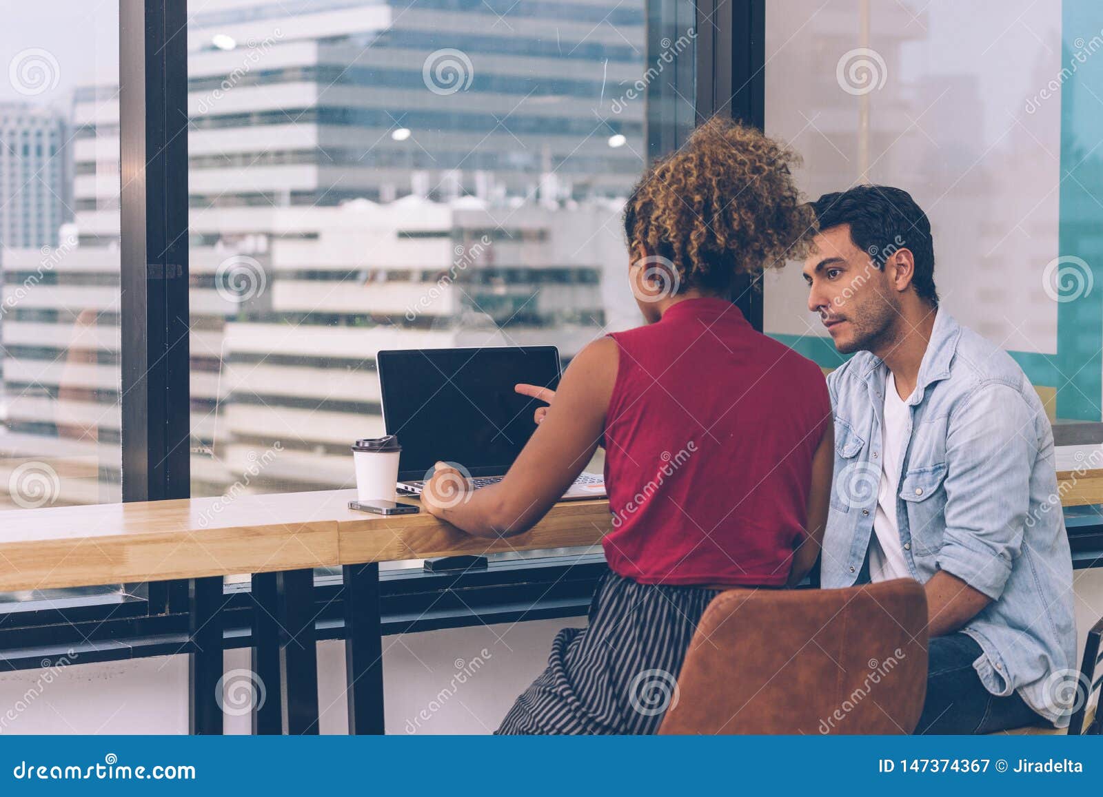 Man and Woman Talking Together about the Work in Laptop Computer Stock ...