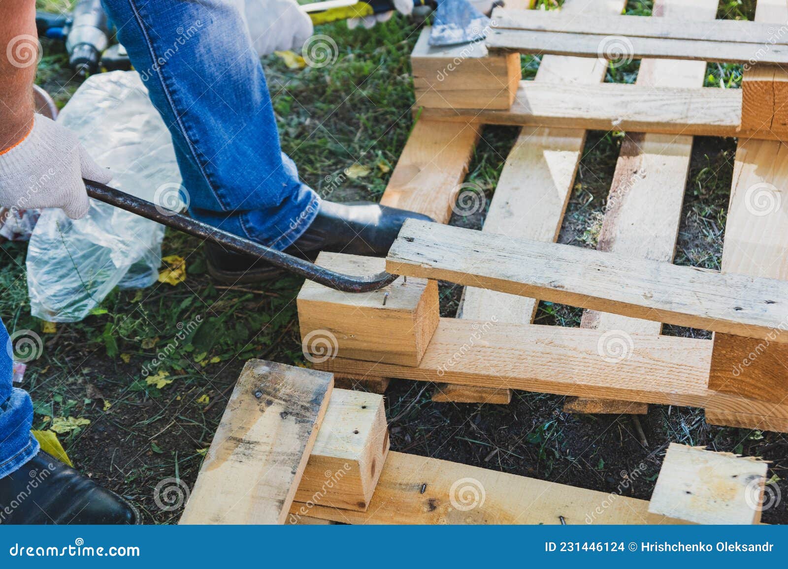 Working with Wooden Pallets. a Man Breaks a Board in a Pallet Stock ...