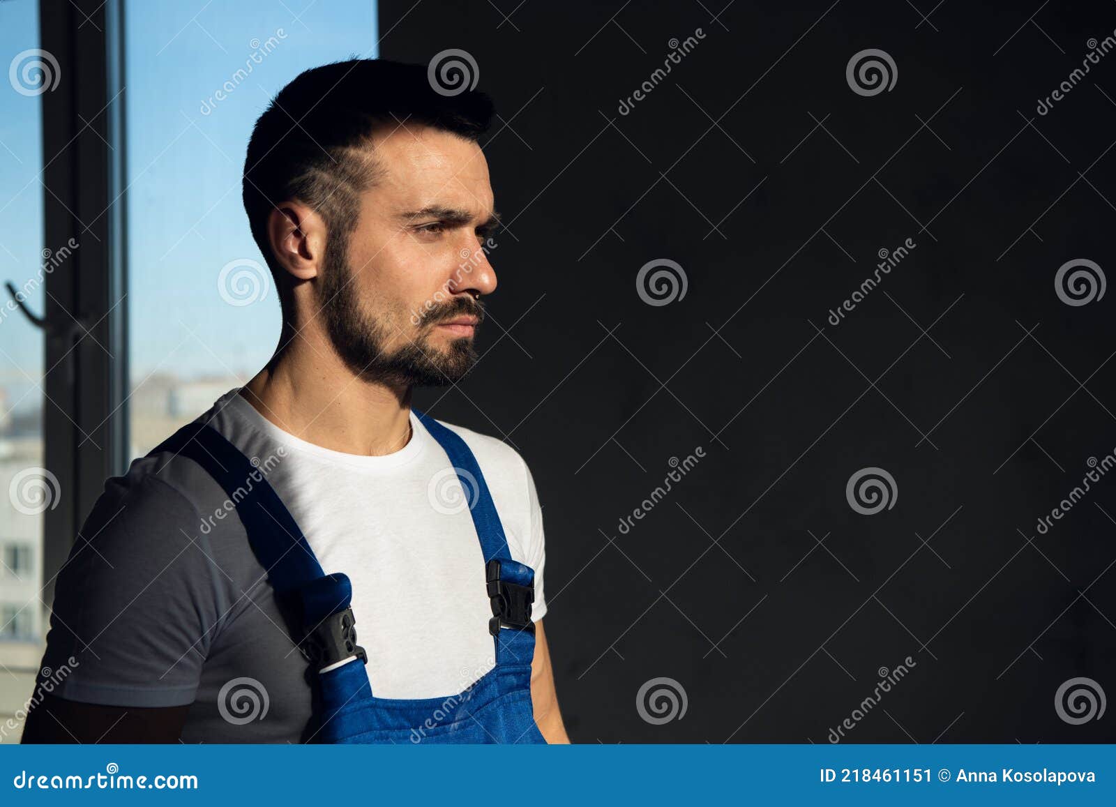 A Workman in a Blue Overalls Stands in the Shade Stock Image - Image of ...