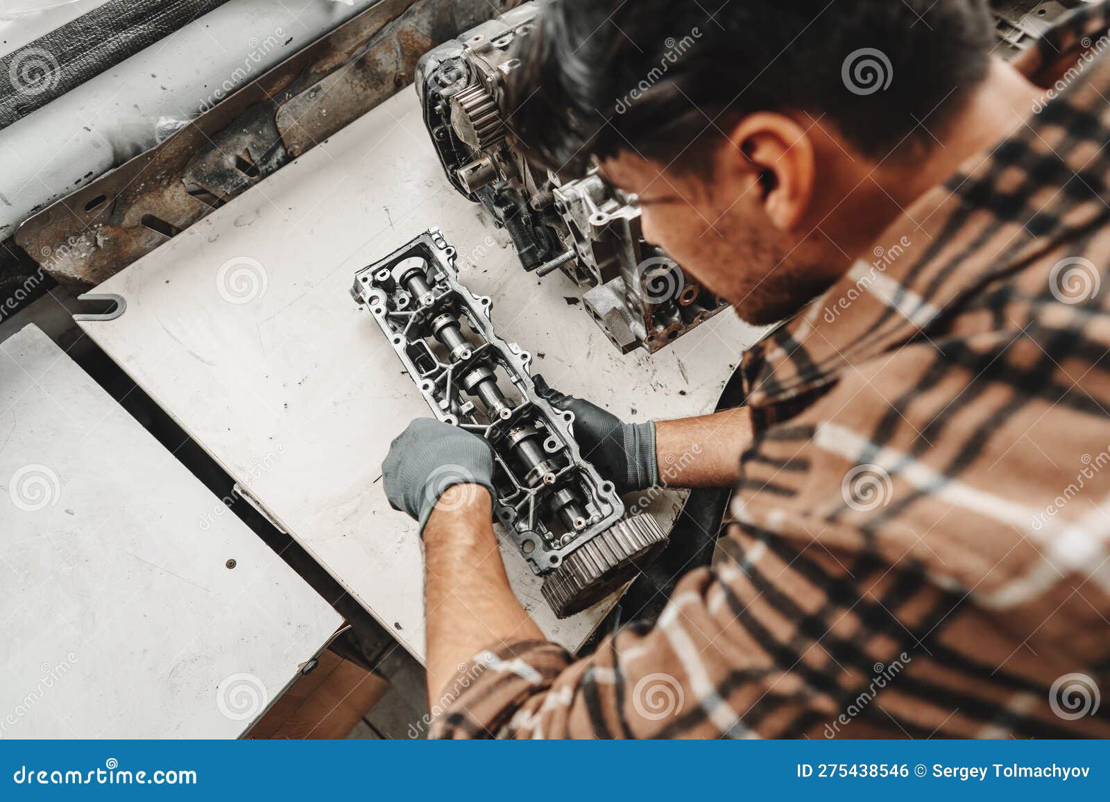 Workman Disassembling Car Engine at the Working Table of the Car ...