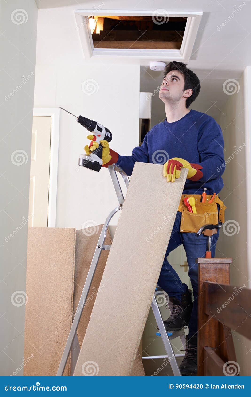 Workman Fitting Boards To Floor of House Loft Stock Photo - Image of ...