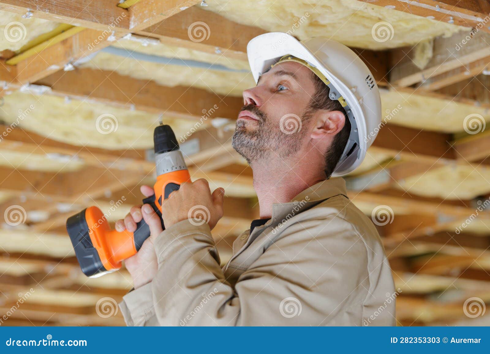 Workman Holding Cordless Drill Looking Up at Roof Timbers Stock Image ...