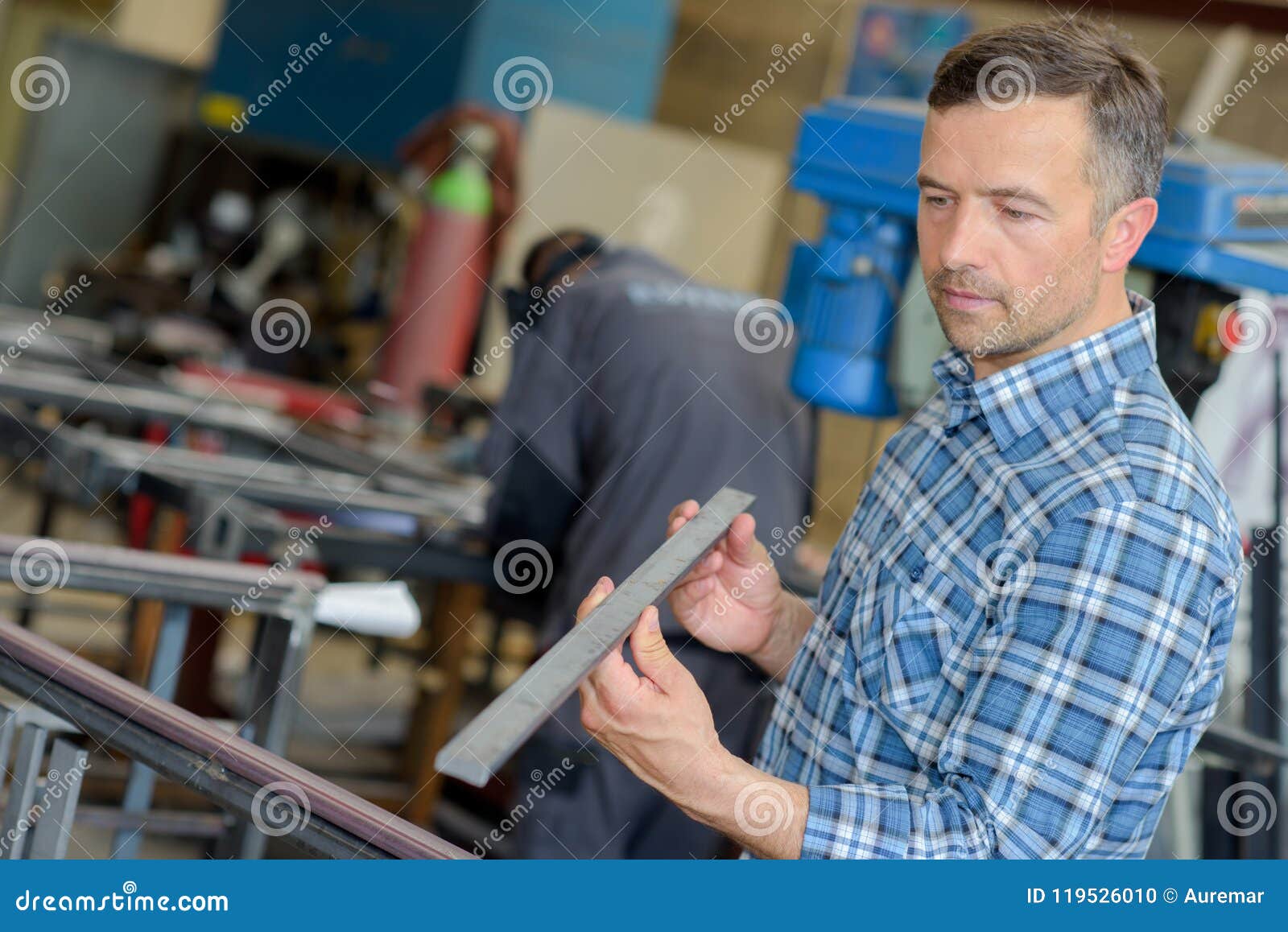 Workman Holding Metal Ruler Stock Photo - Image of industrial, ruler ...