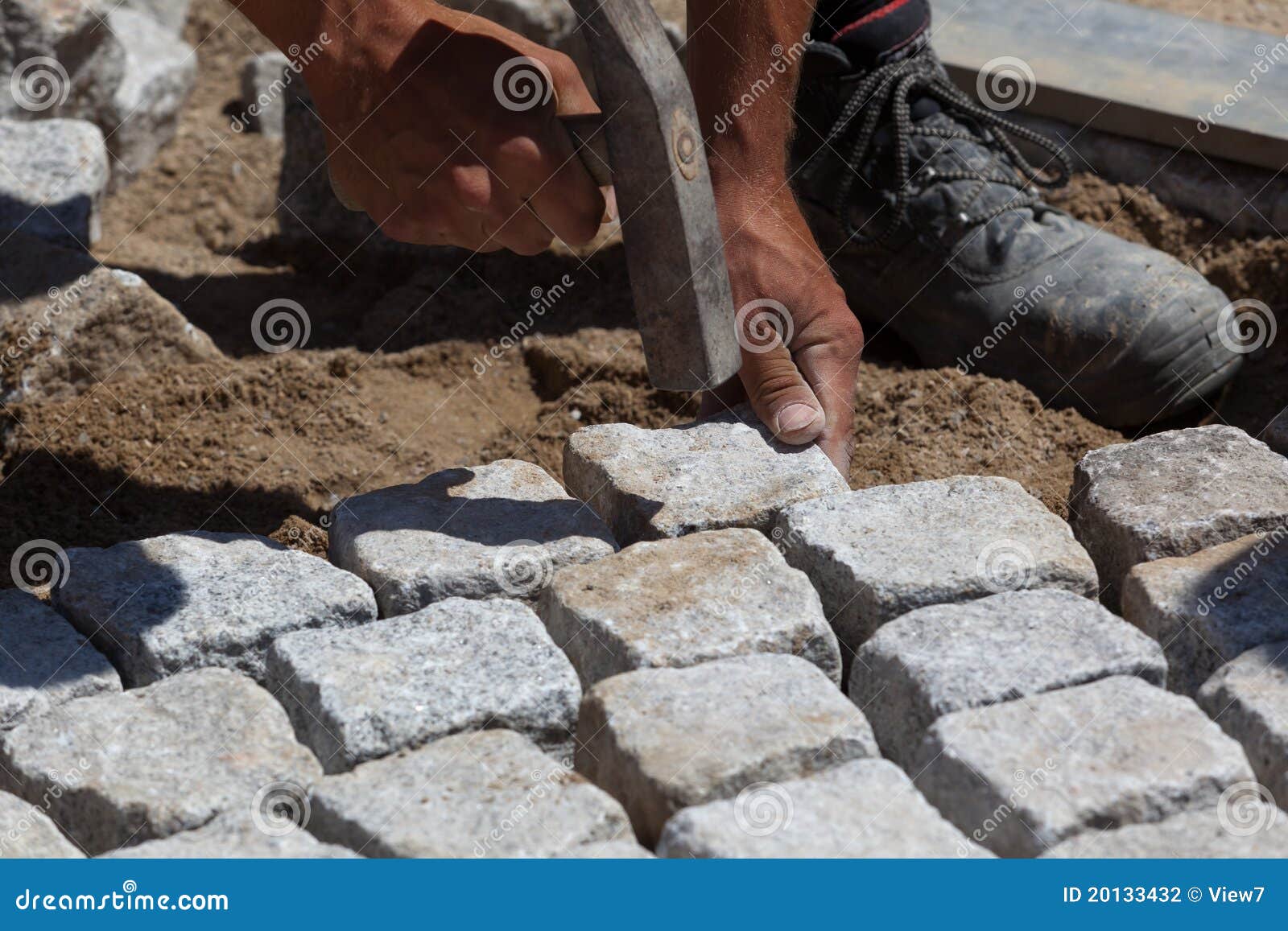 Workman laying cobbles stock photo. Image of activity - 20133432
