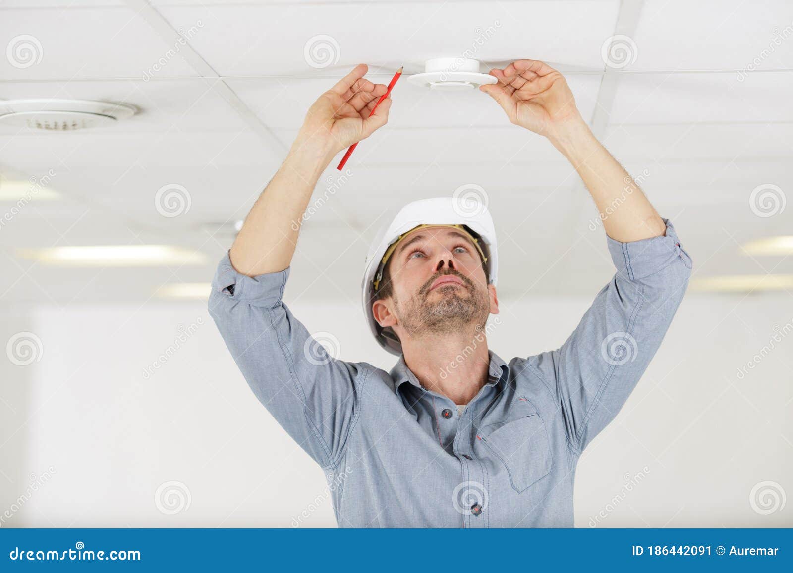 Workman Marking Spot with Pencil on Ceiling Stock Image - Image of mark ...
