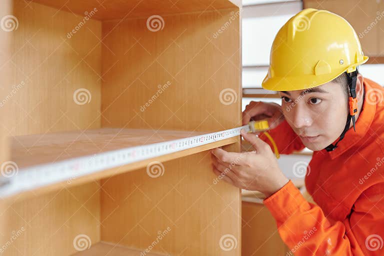 Workman Measuring Shelves stock photo. Image of house - 234648628