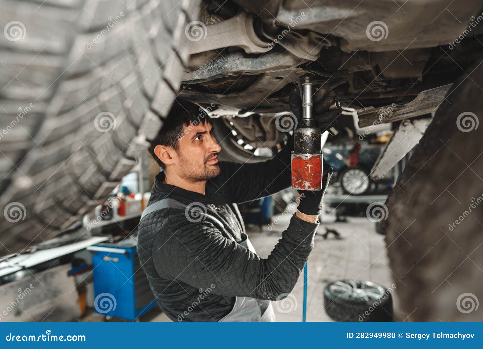 Workman Mechanic Working Under Car in Auto Repair Shop Stock Photo ...