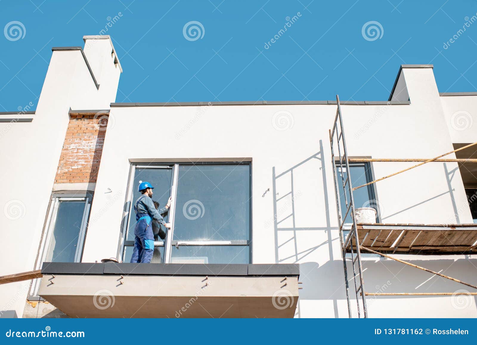 Workman mounting window stock photo. Image of craftsman - 131781162