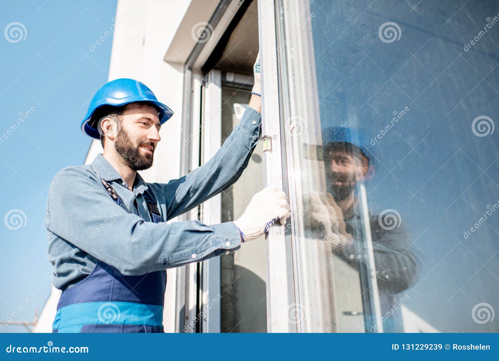 Workman mounting windows stock image. Image of reflection - 131229239
