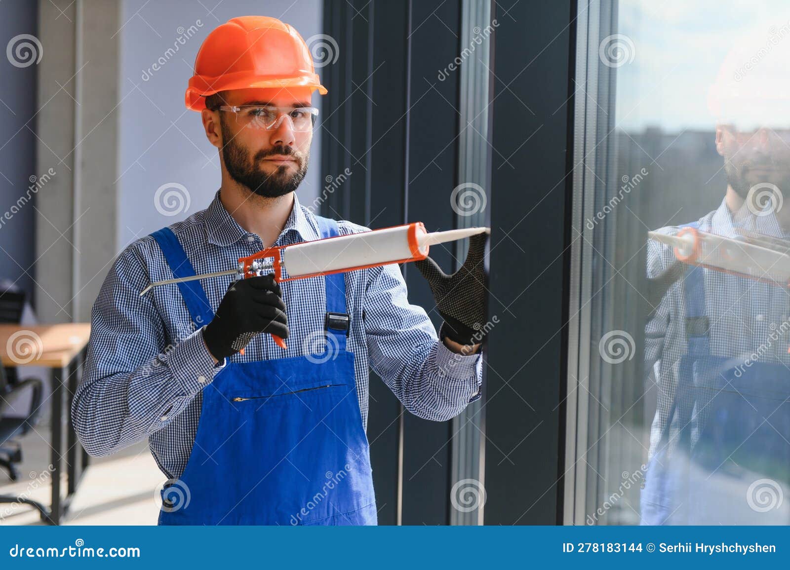 Workman in Overalls Installing or Adjusting Plastic Windows in the Living Room at Home Stock ...