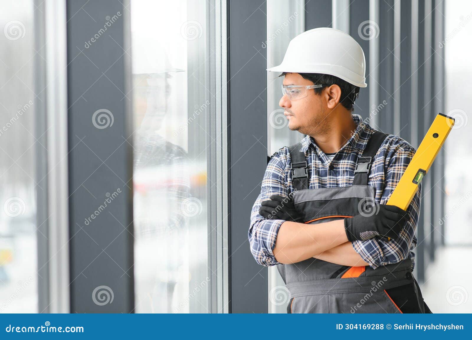Workman in Overalls Installing or Adjusting Plastic Windows Stock Photo ...