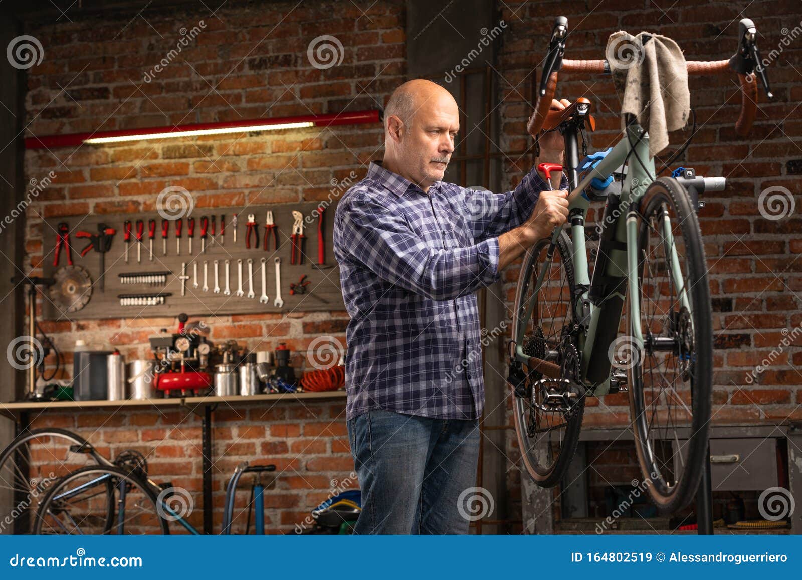 Workman Repairing a Bicycle in a Workshop Stock Image - Image of senior ...
