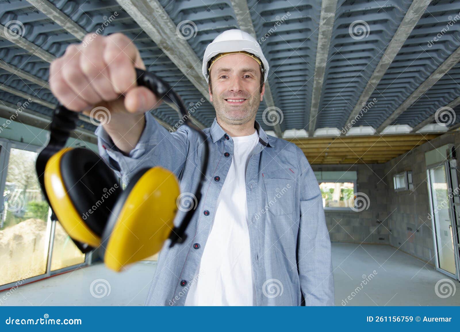 Workman Shows Ear Protection Stock Image - Image of isolated, engineer ...