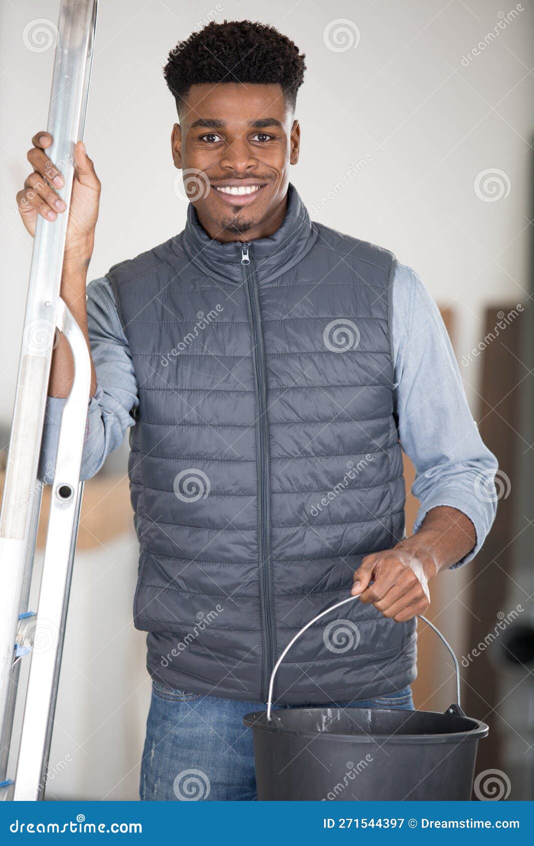Workman on Site Carrying Stepladder and Bucket Stock Image - Image of ...