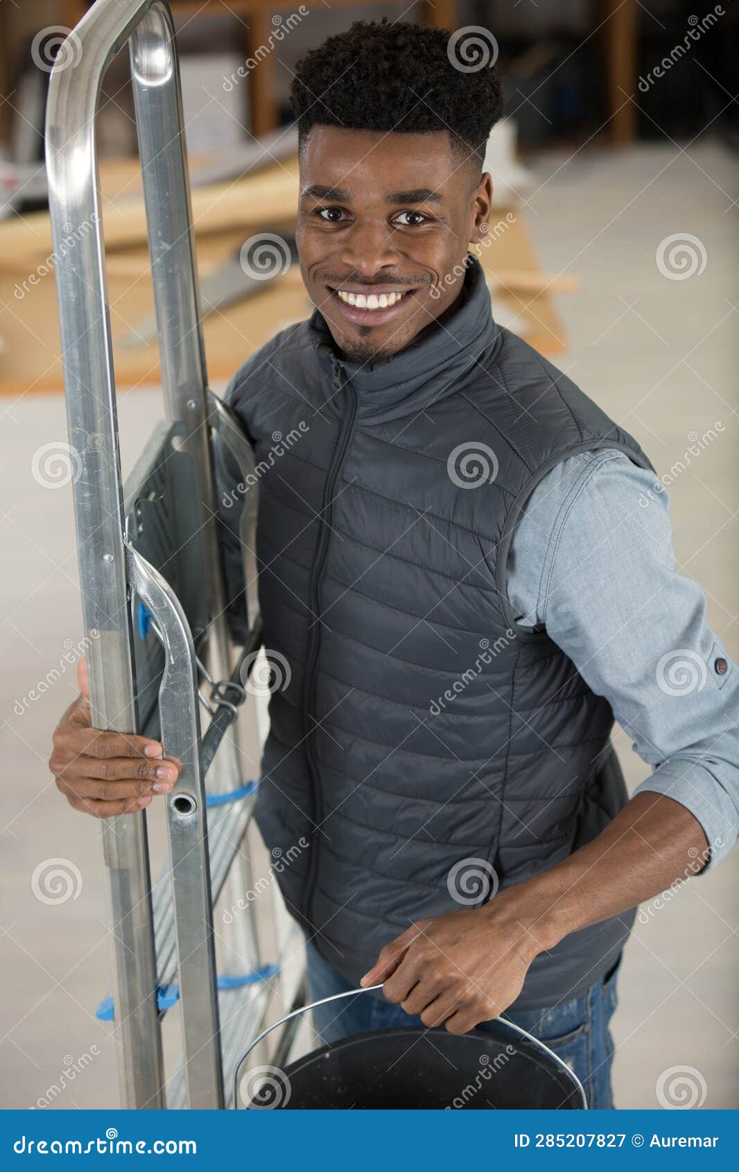 Workman on Site Carrying Stepladder and Bucket Stock Image - Image of ...