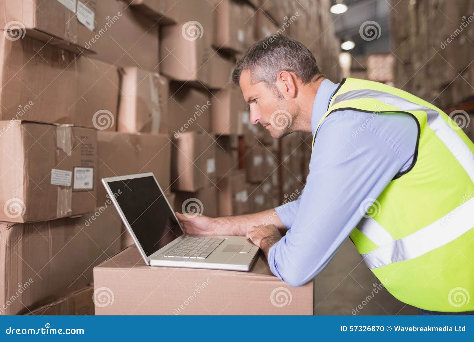 Workman Using Laptop at Warehouse Stock Photo - Image of laptop ...