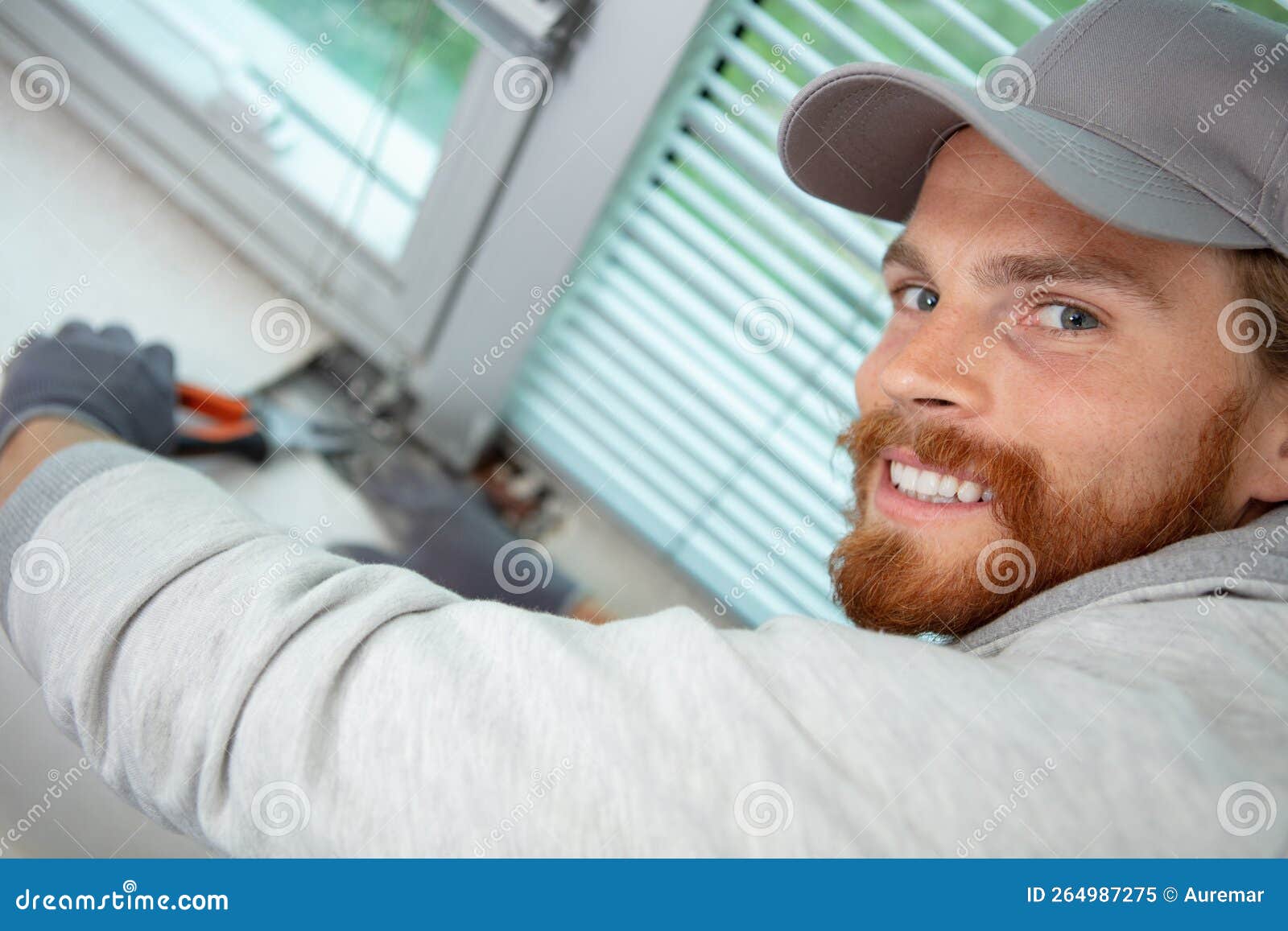 Workman Using Pliers by Window Stock Image - Image of casual, window ...