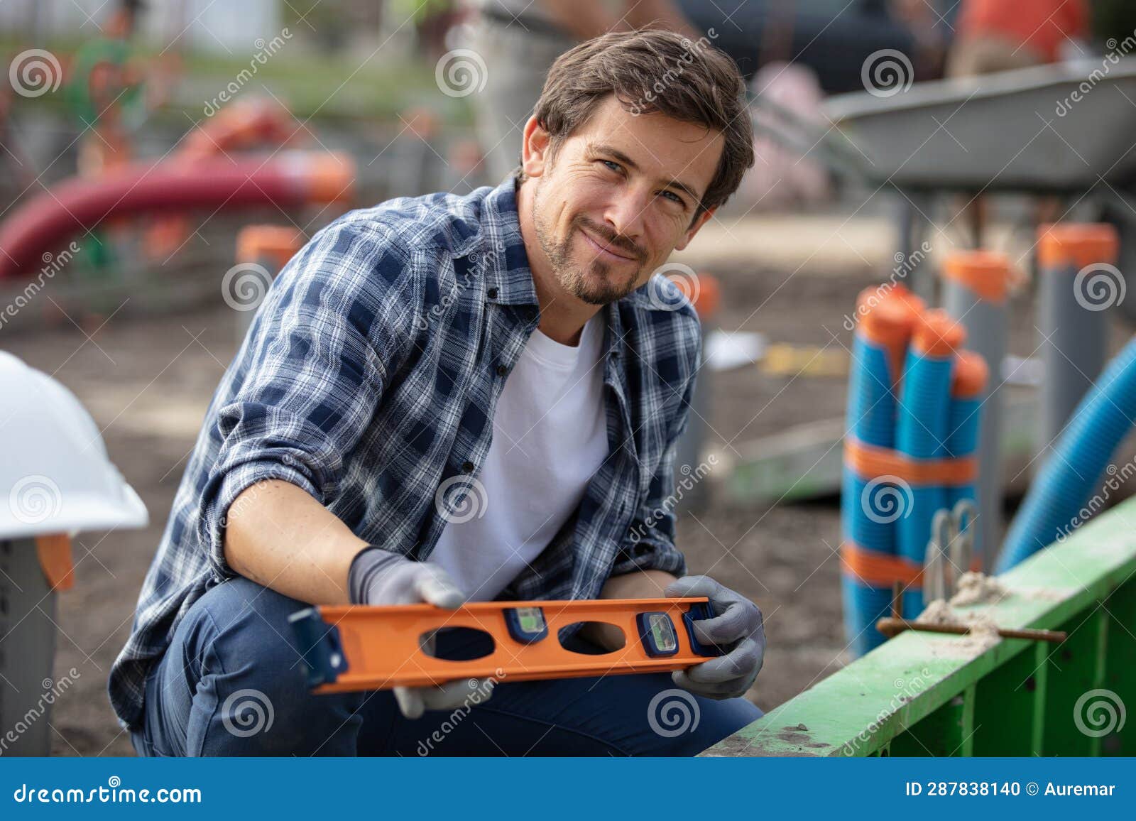 Workman Using Spirit Level on Construction Site Stock Photo - Image of professional, blurry ...