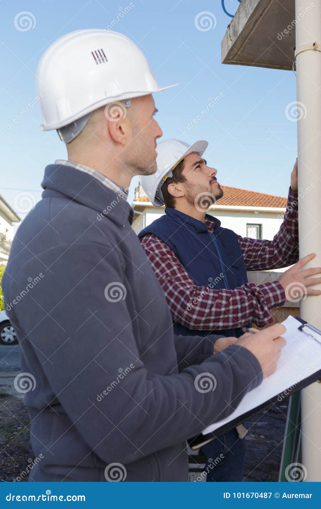Workmen Assessing Drainpipe on Outside Building Stock Image - Image of ...