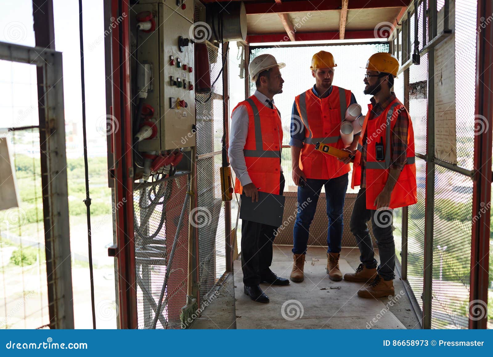 Workmen in Construction Elevator Stock Image - Image of crane ...