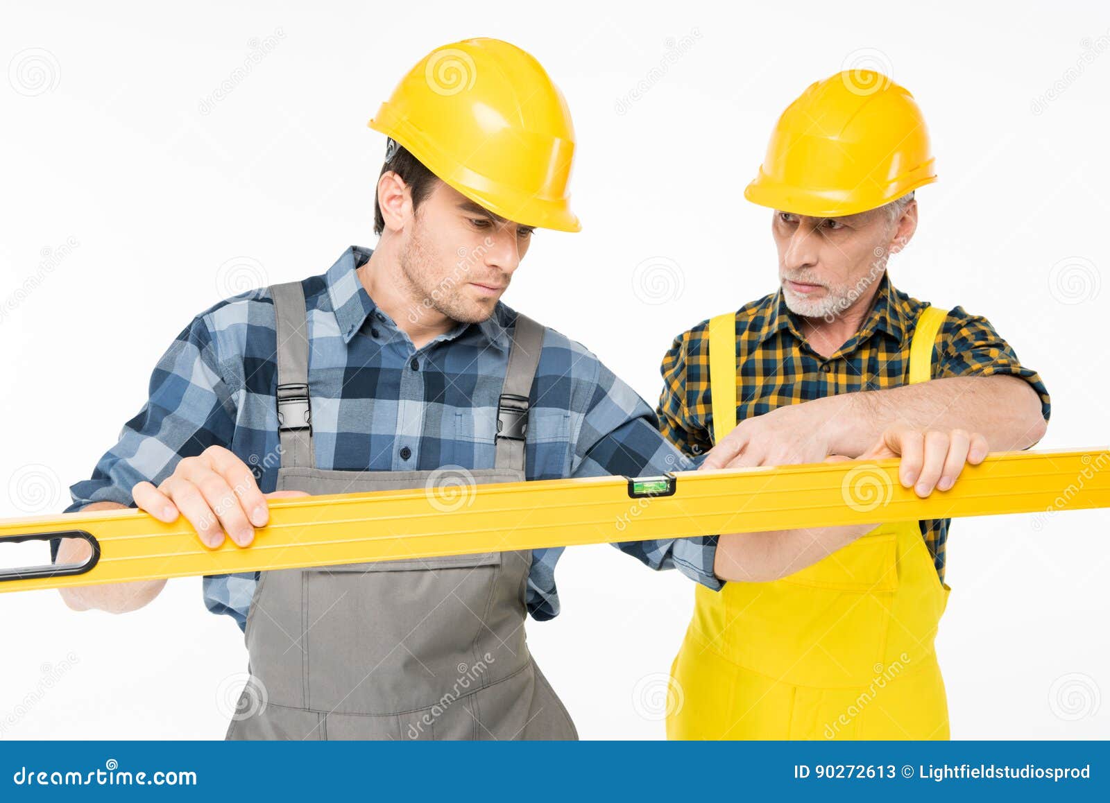 Workmen with level tool stock image. Image of helmets - 90272613