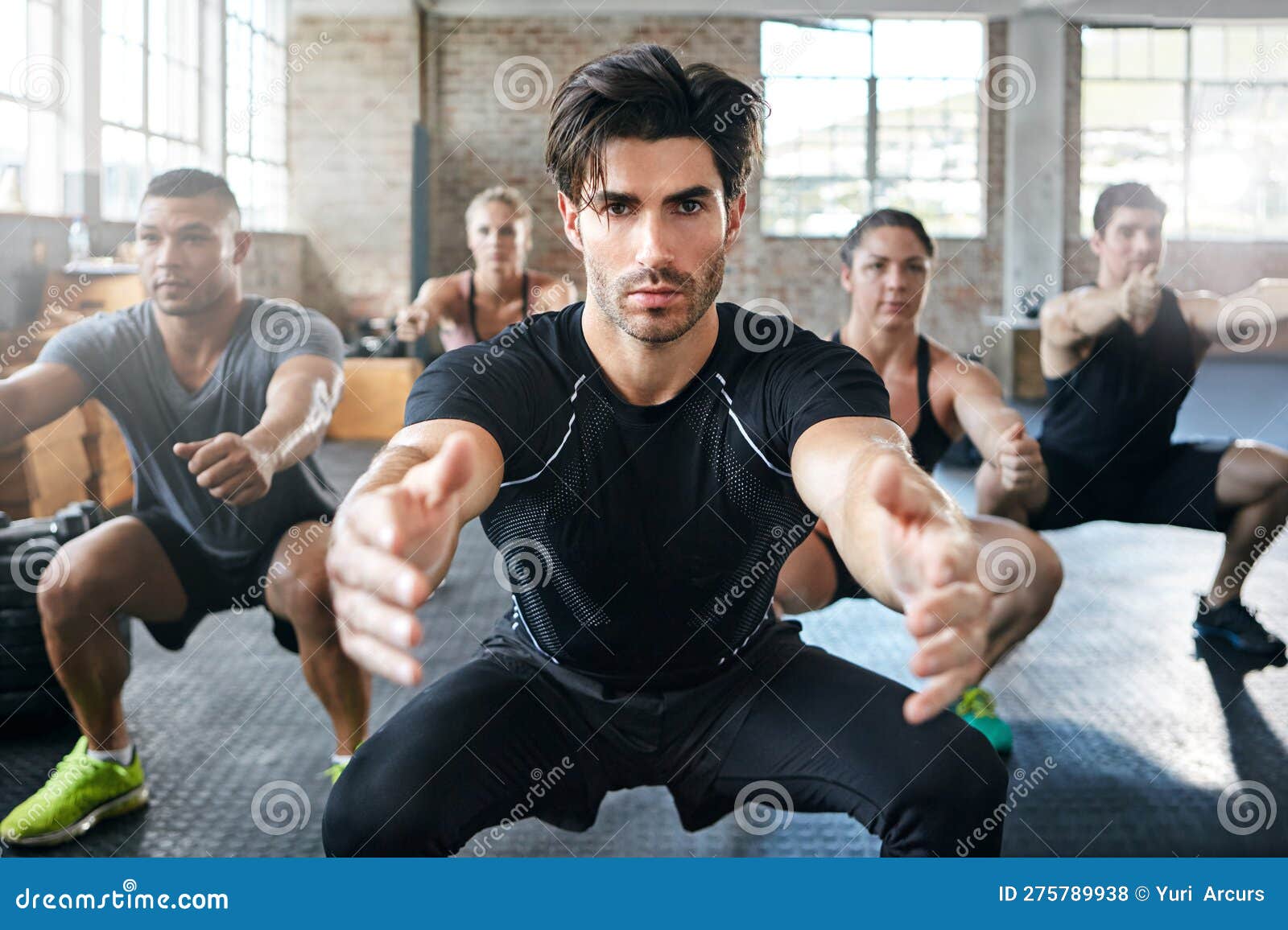 Workouts that Burn. a Group of People Doing Squats in a Gym. Stock ...