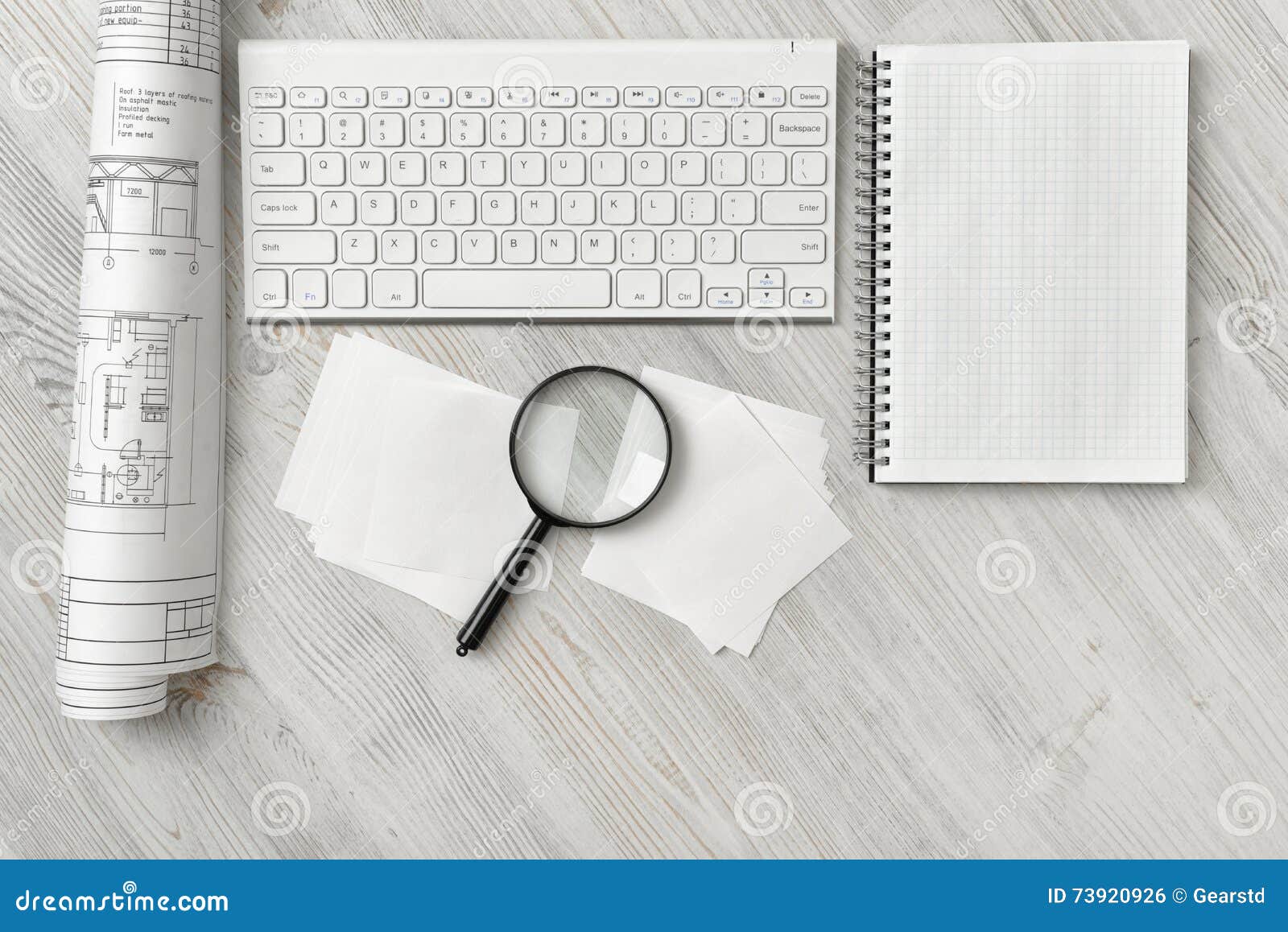 Workplace with Architectural Drawings, Keyboard, Magnifier and Notepad ...