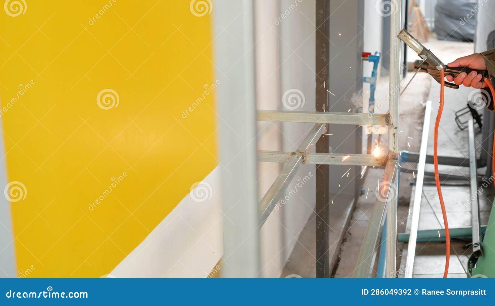 Works with Metal Using a Welding Machine, Bright Sparks, and Flashes in ...