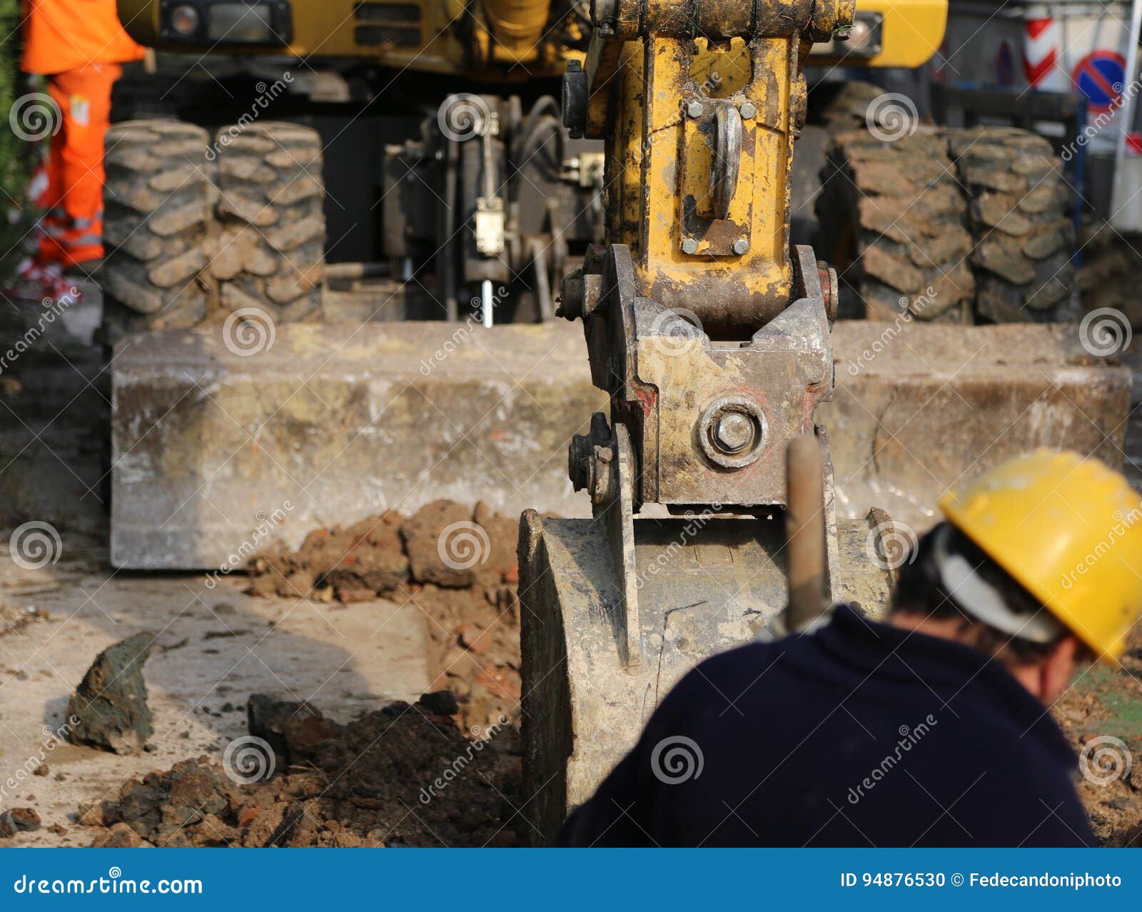 Works on a Road Construction Site with the Digger and the Worker Stock ...