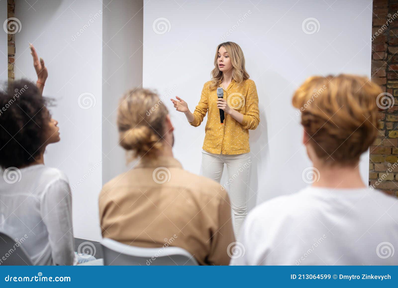 Blonde Coach with a Microphone Talking To the Audience Stock Image ...