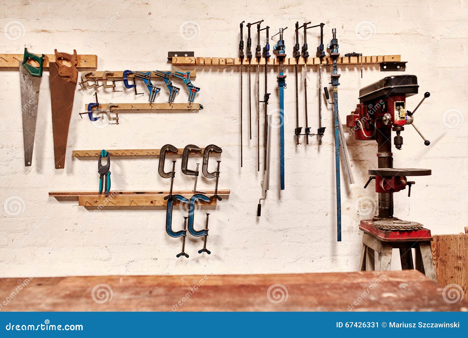 Workshop Wall with Tools in Rows Alongside a Drill Press Stock Image ...