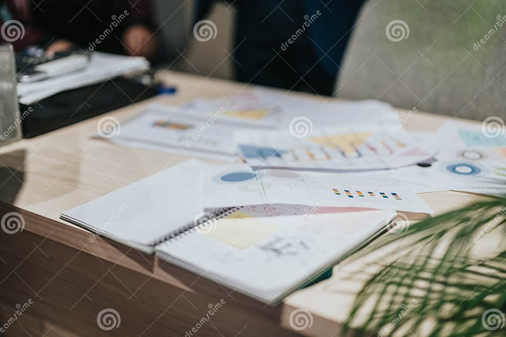 Workspace Desk Displaying Documents and Graphs for Business Analysis ...