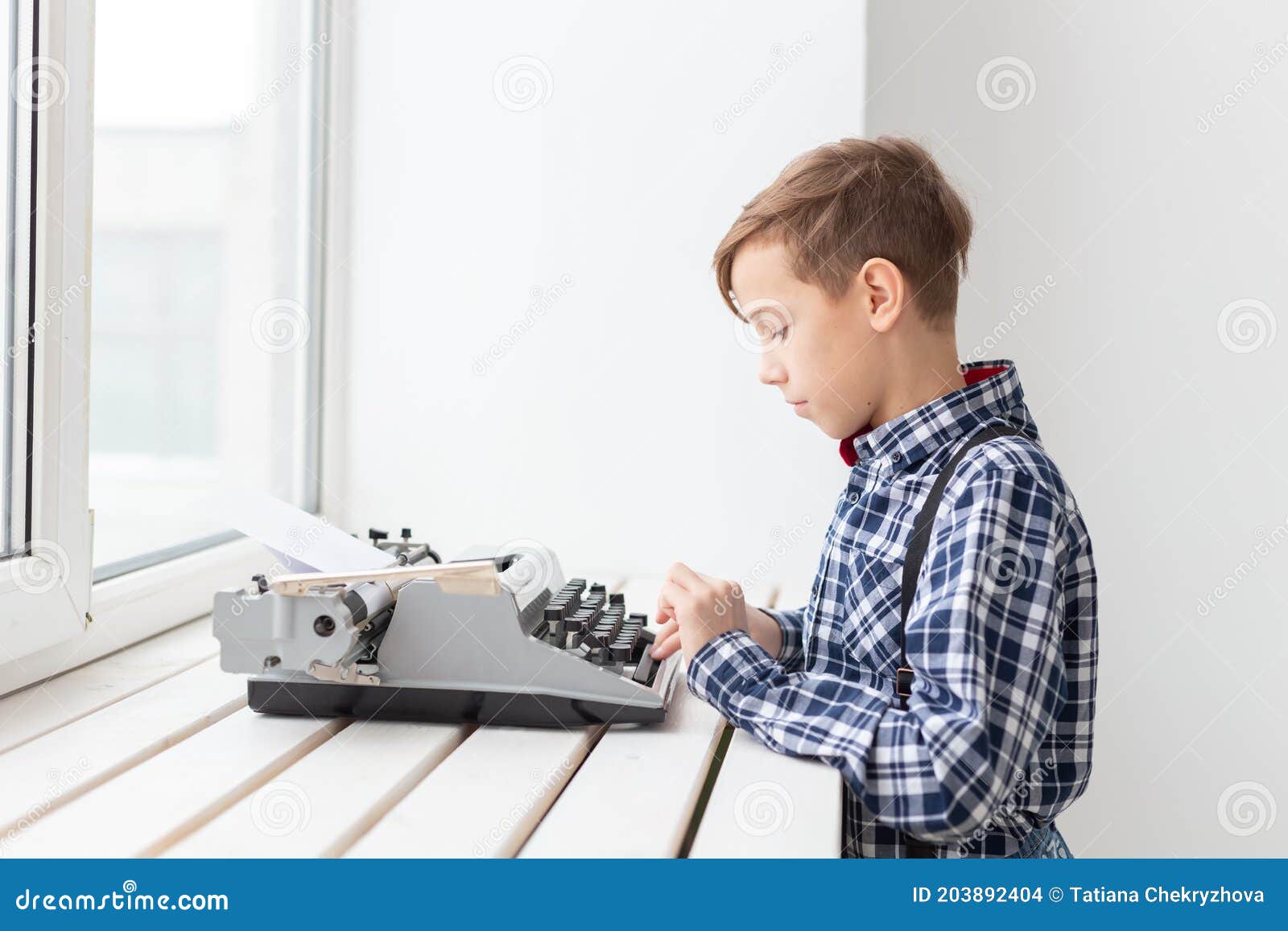 World Day of the Writer Concept - Boy with an Old Typewriter Over ...