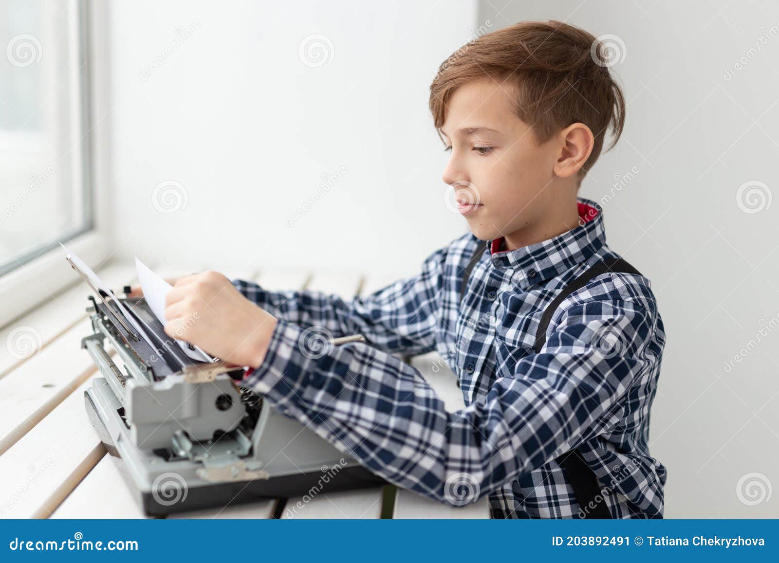 World Day of the Writer Concept - Boy with an Old Typewriter Over ...