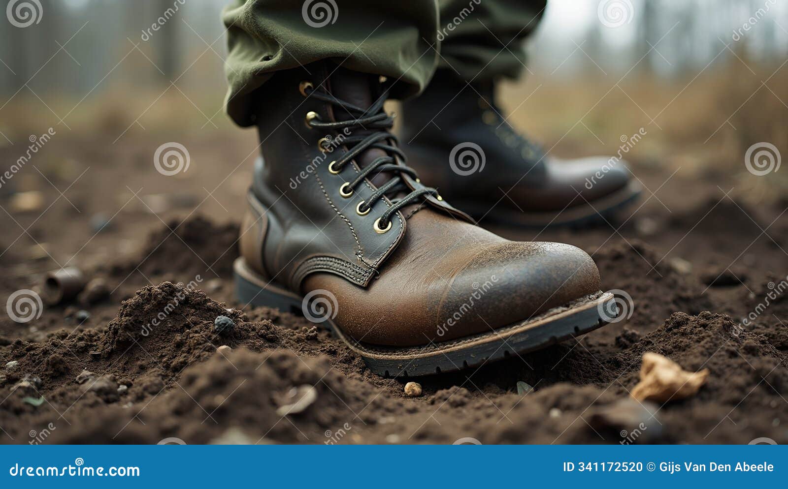 Worn Soldiers Boot in Dirt with Scuff Marks and Mud Symbolizing Loss ...