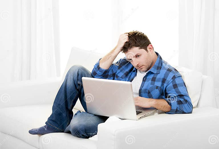 Worried Attractive Man with Computer Sitting on Couch Stock Photo ...