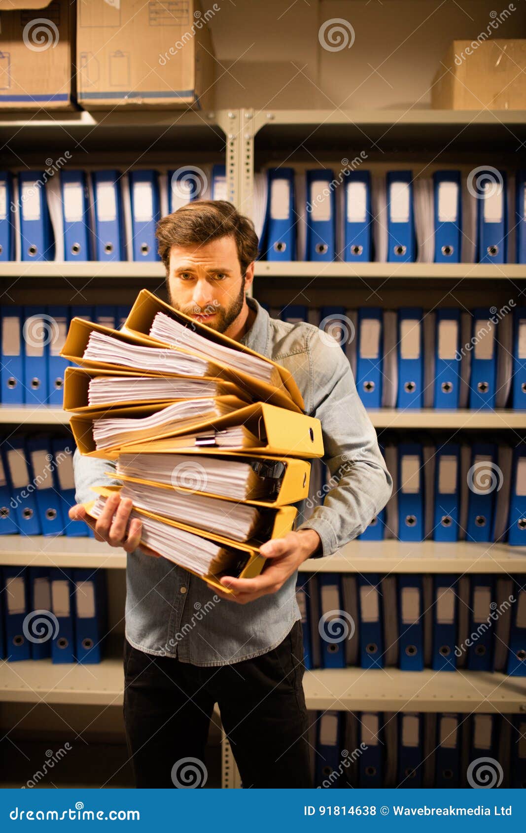 Worried Businessman Holding Files in Storage Room Stock Photo - Image ...