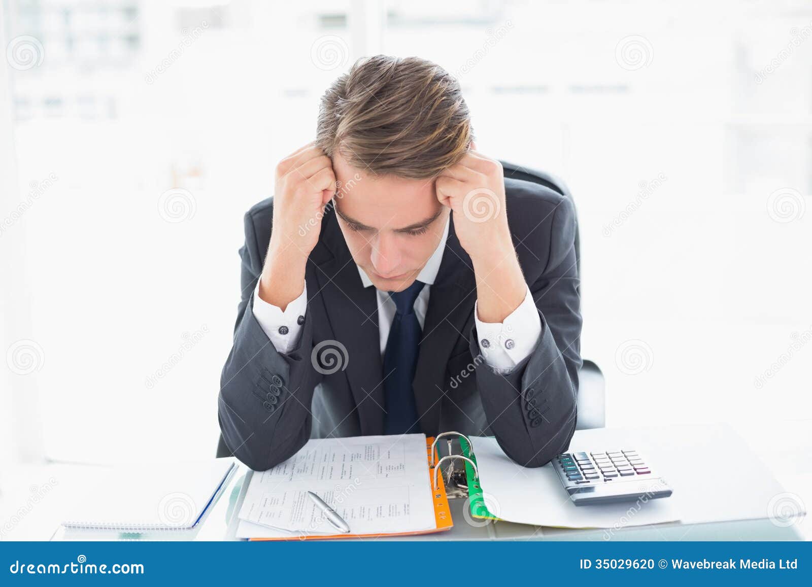 Worried Businessman Looking at Documents in Office Stock Photo - Image ...