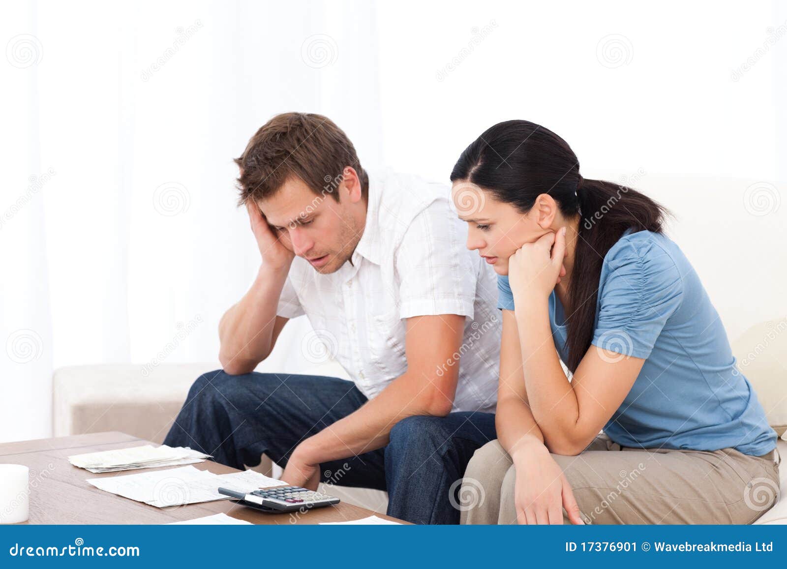 Worried Couple Looking at Their Bills on the Sofa Stock Image - Image ...