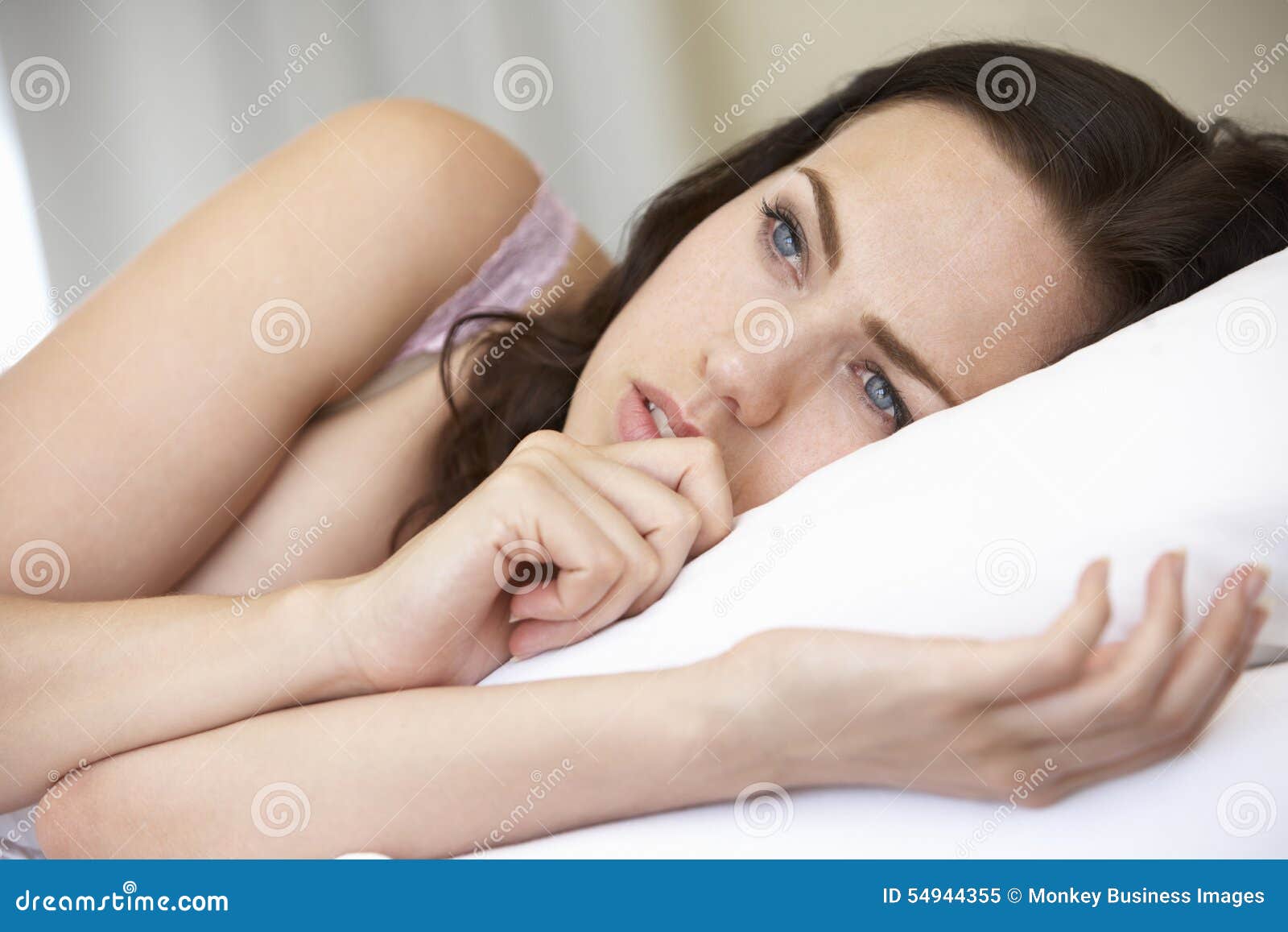 Worried Looking Young Woman on Bed Stock Image - Image of person ...