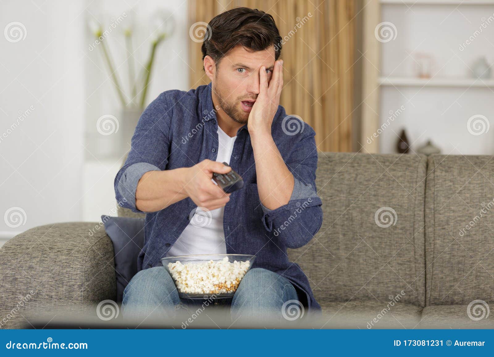 Worried man eating popcorn stock image. Image of handsome - 173081231