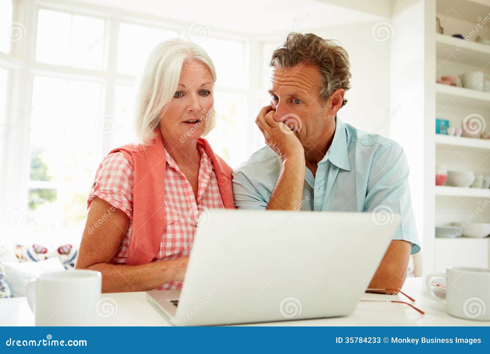 Worried Middle Aged Couple Looking at Laptop Stock Image - Image of ...