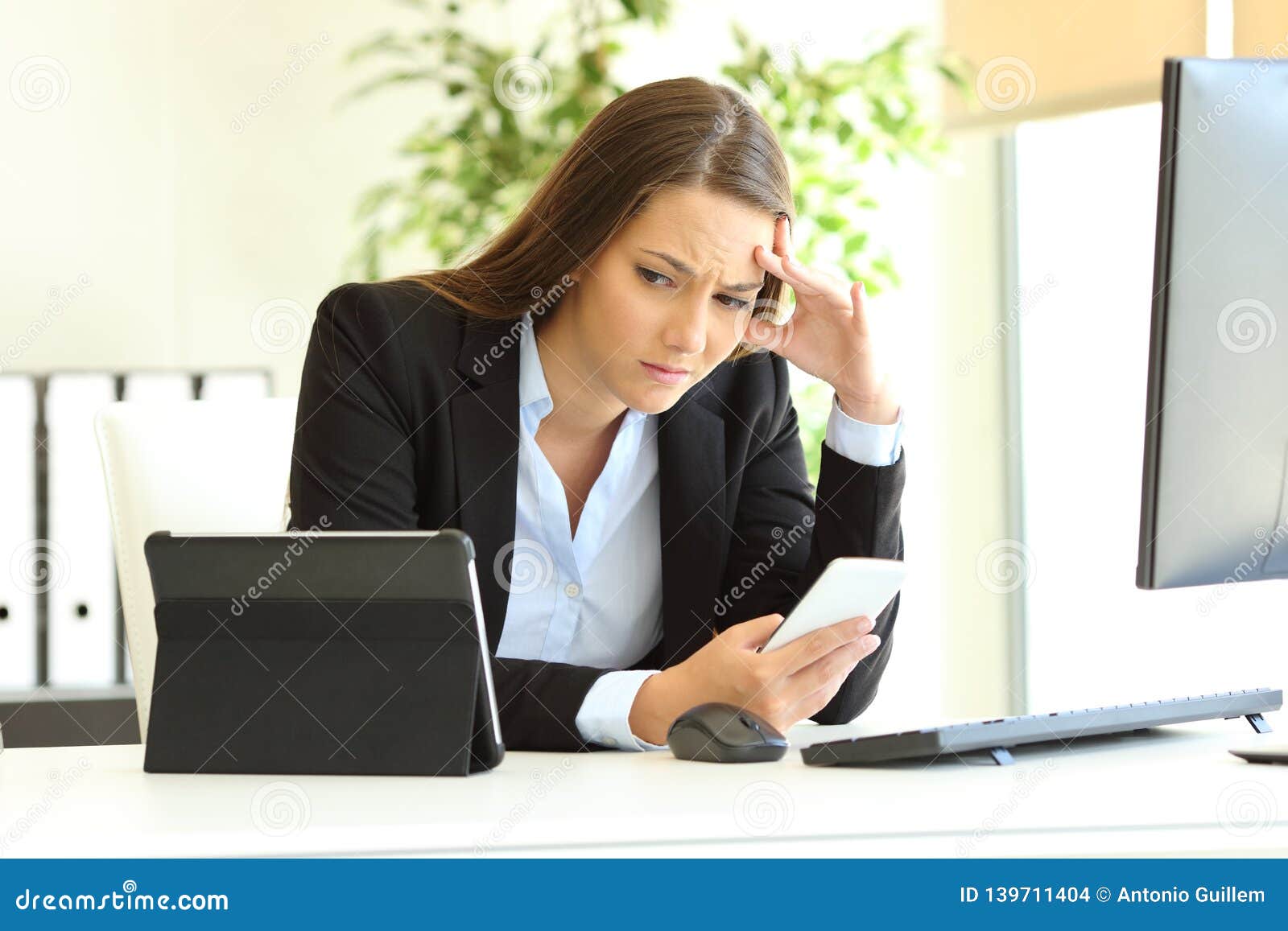 Worried Office Worker Using Multiple Devices Stock Photo - Image of ...