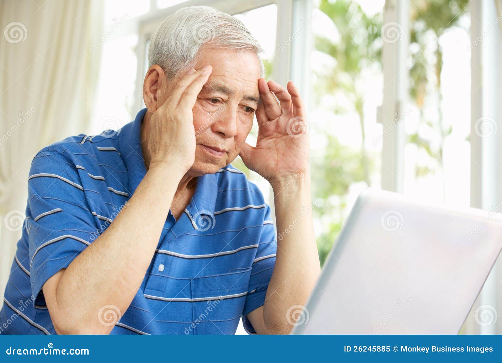 Worried Senior Chinese Man Using Laptop At Home Royalty Free Stock ...