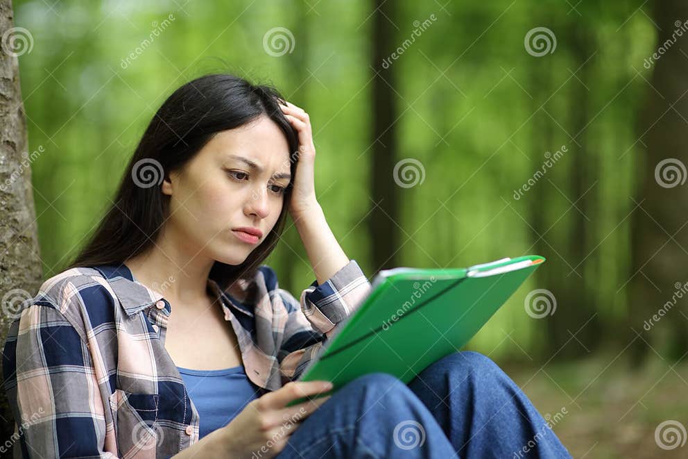 Worried Student in a Park Reading Notes Stock Photo - Image of disorder ...
