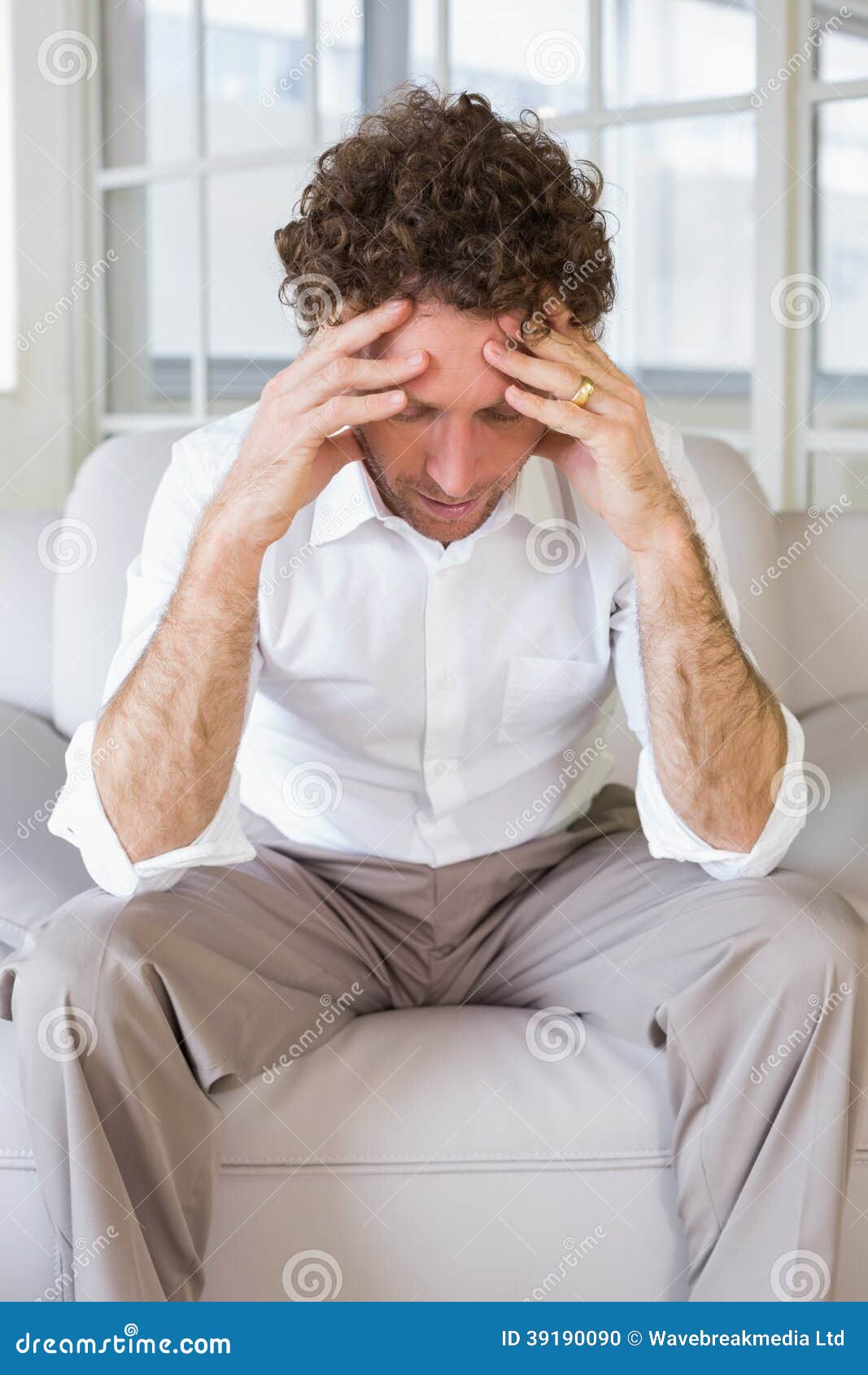 Worried Well Dressed Man Sitting with Head in Hands on Sofa in the ... Worried Well Dressed Man Sitting with Head in Hands on Sofa in the ...