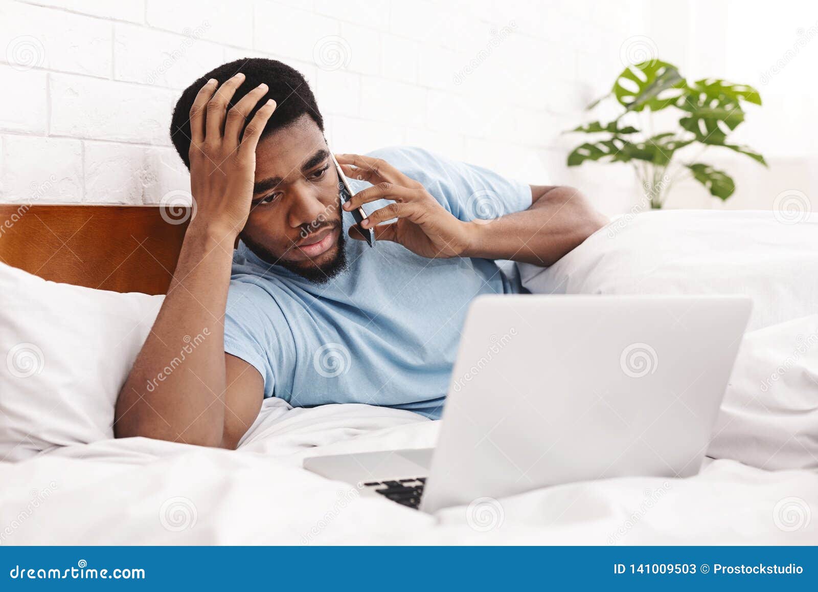Worried Workaholic Working with Mobile Phone and Laptop Stock Image ...