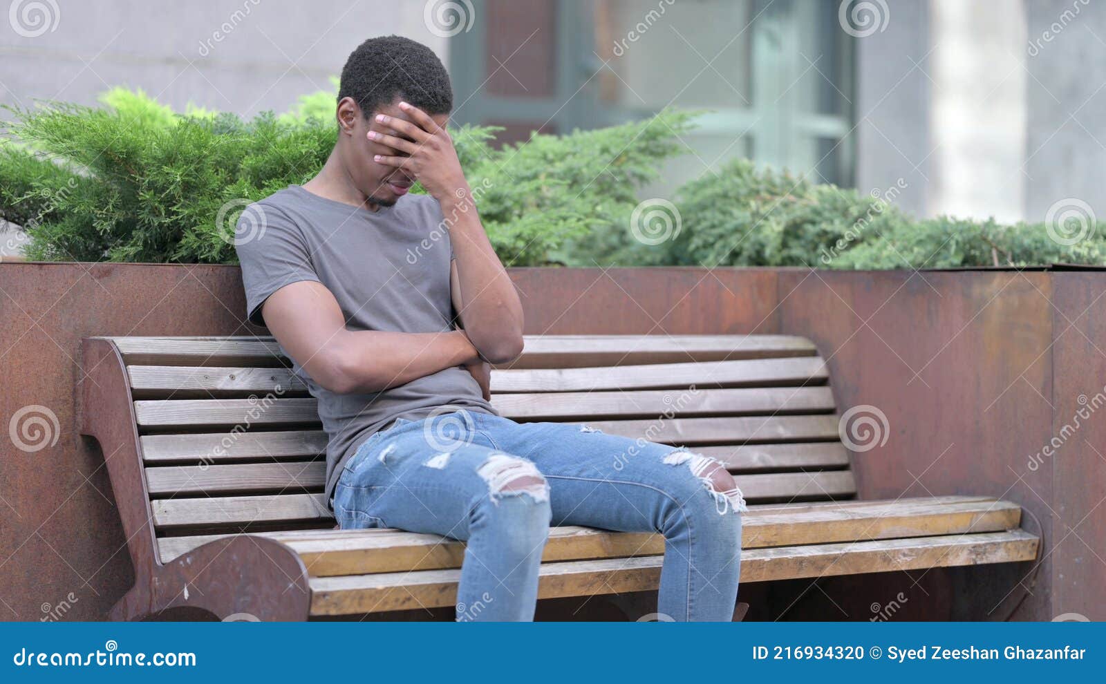 Worried Young Young African Man Sitting on Bench and Thinking Stock ...